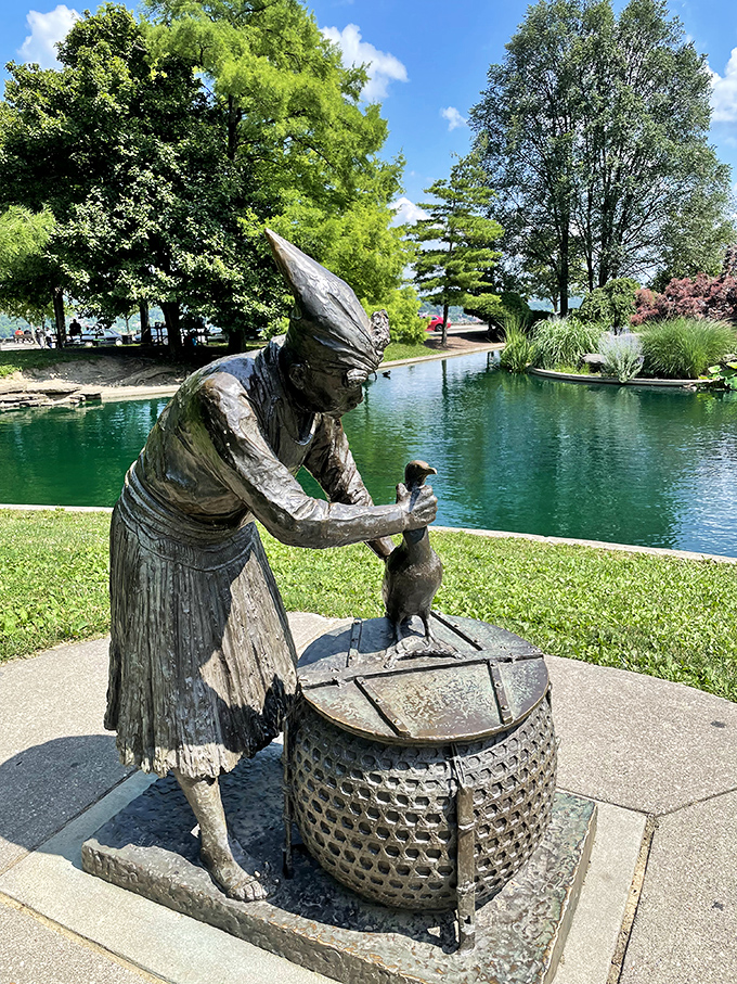 The Cormorant Fisherman sculpture captures an ancient tradition in bronze, eternally patient beside tranquil waters.