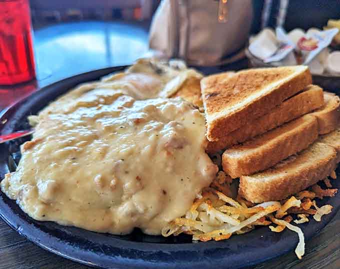 Country fried steak smothered in peppery gravy alongside golden toast&mdash;comfort food that hugs your soul from the inside.