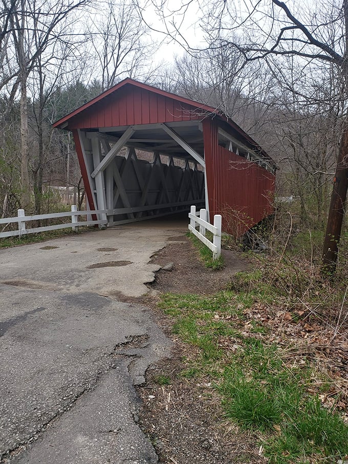 Classic Americana preserved in this red covered bridge, where horse-drawn carriages once clattered across wooden planks.