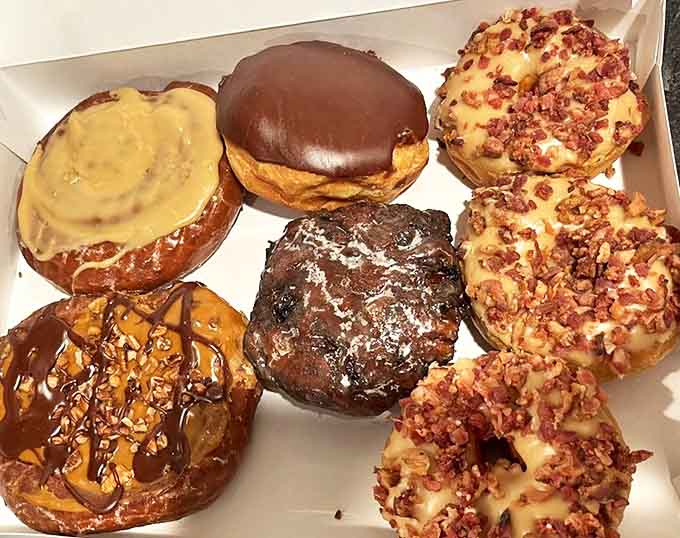A box of assorted donuts that turns your car into the most popular place in town during the drive home.