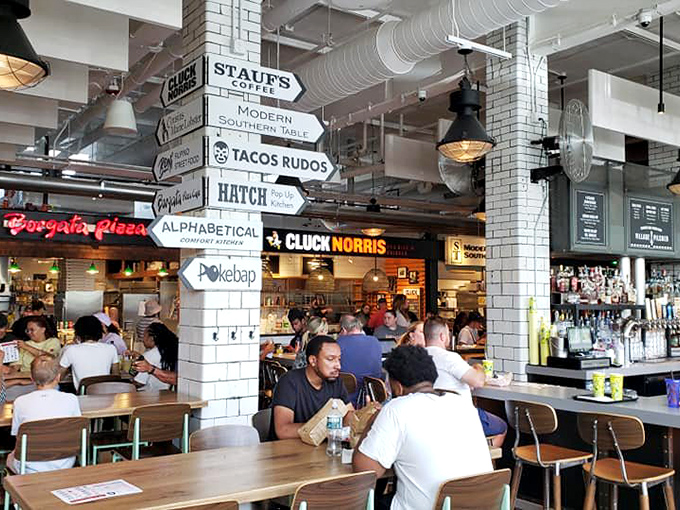 The food hall buzzes with energy as diners navigate between vendors, each directional sign pointing to a different delicious possibility.