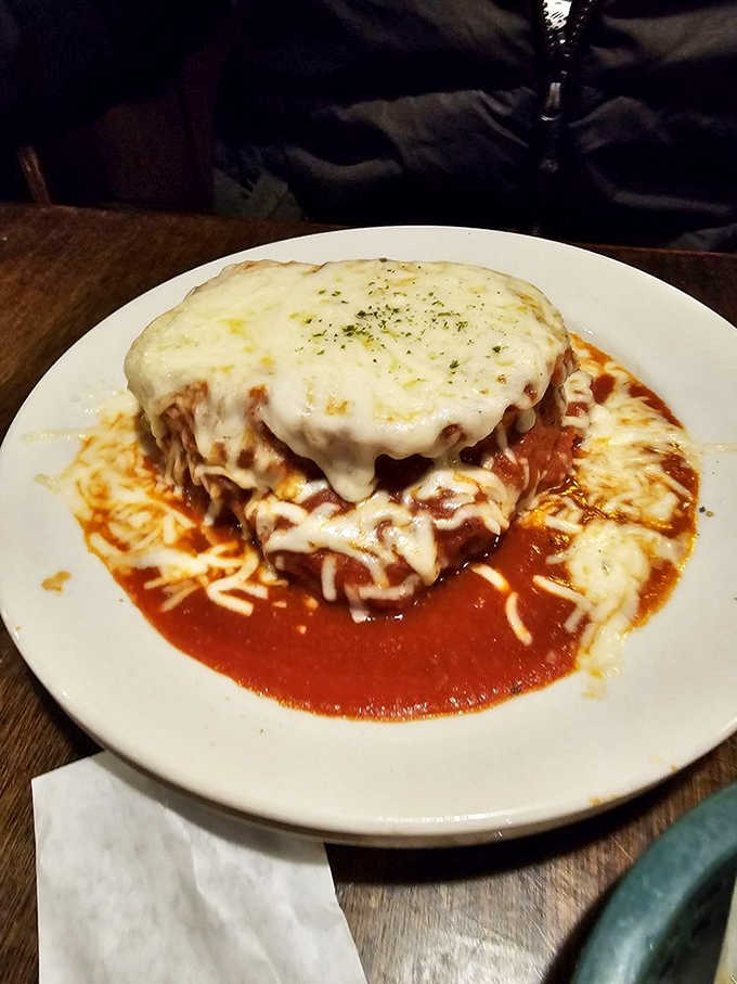 The legendary sandwich arrives like an edible architecture project &ndash; fried goodness topped with that signature red sauce that's worth every napkin you'll need.
