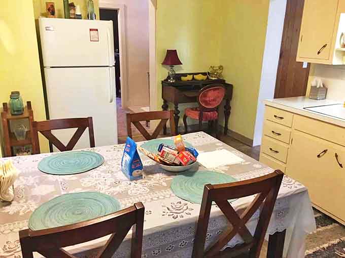 Turquoise placemats pop against the lace tablecloth, creating a dining space that's both nostalgic and Instagram-ready.