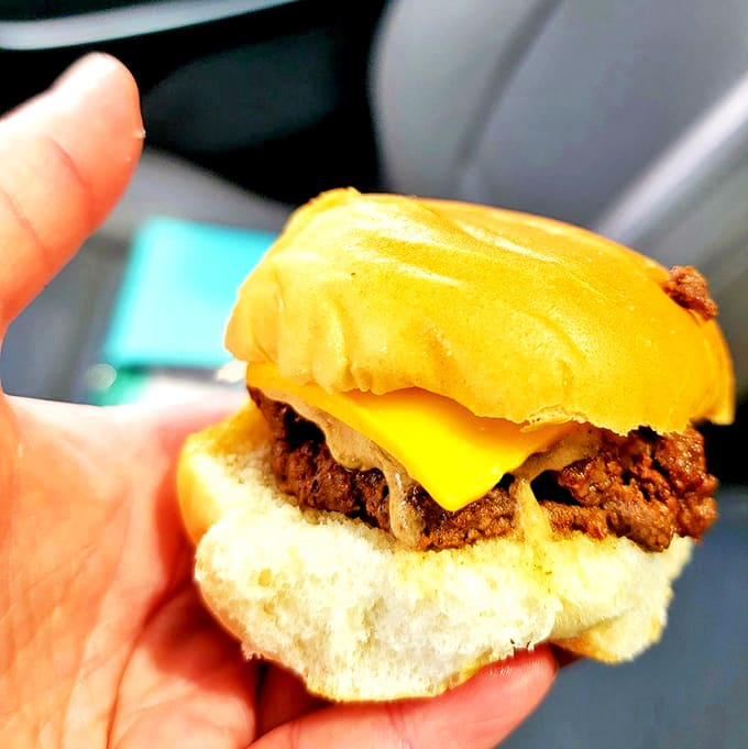 Behold the double cheeseburger in all its glory! Two perfectly seared patties with melty American cheese create a harmonious meat-to-cheese ratio.