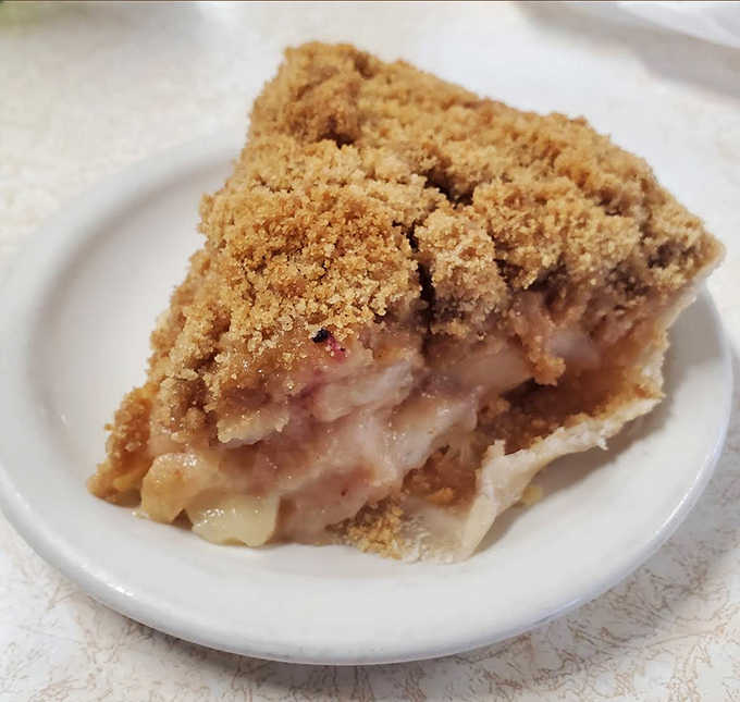 Dutch apple pie crowned with buttery crumb topping &ndash; the kind that makes you question why anyone would choose diet over dessert.