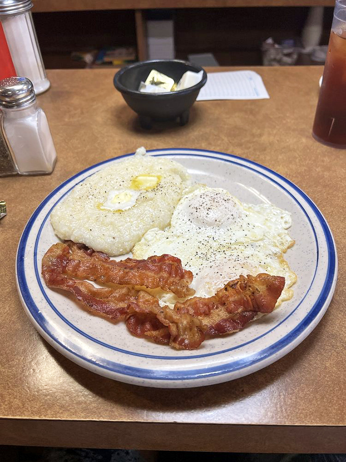 Breakfast fundamentals executed flawlessly &ndash; sunny-side up eggs, crispy bacon, and grits that would make any Southerner nod in approval.