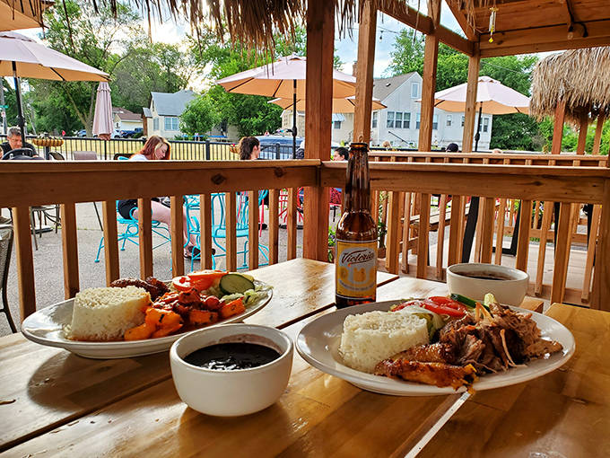 Paradise found on a wooden deck, where cold Cristal beer and hot plates create vacation vibes without the airfare.