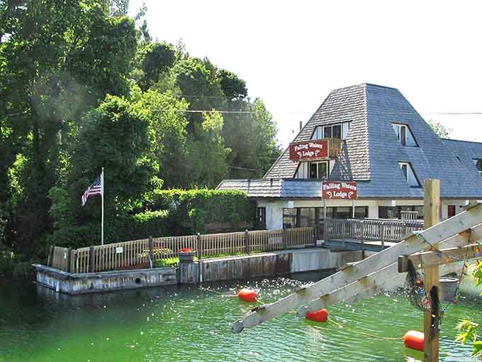 The distinctive pyramid-roofed lodge watches over rushing waters, offering front-row seats to nature's constant performance.