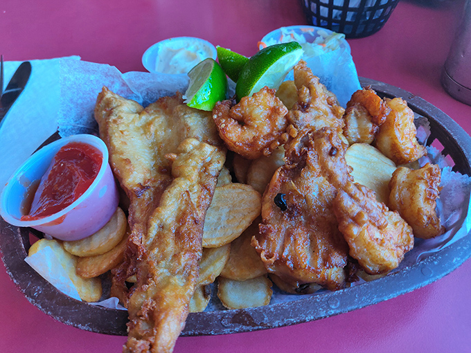 The ultimate seafood indulgence &ndash; golden fish and shrimp nestled beside crispy fries, a feast that captures the essence of coastal Florida on one sizzling plate.