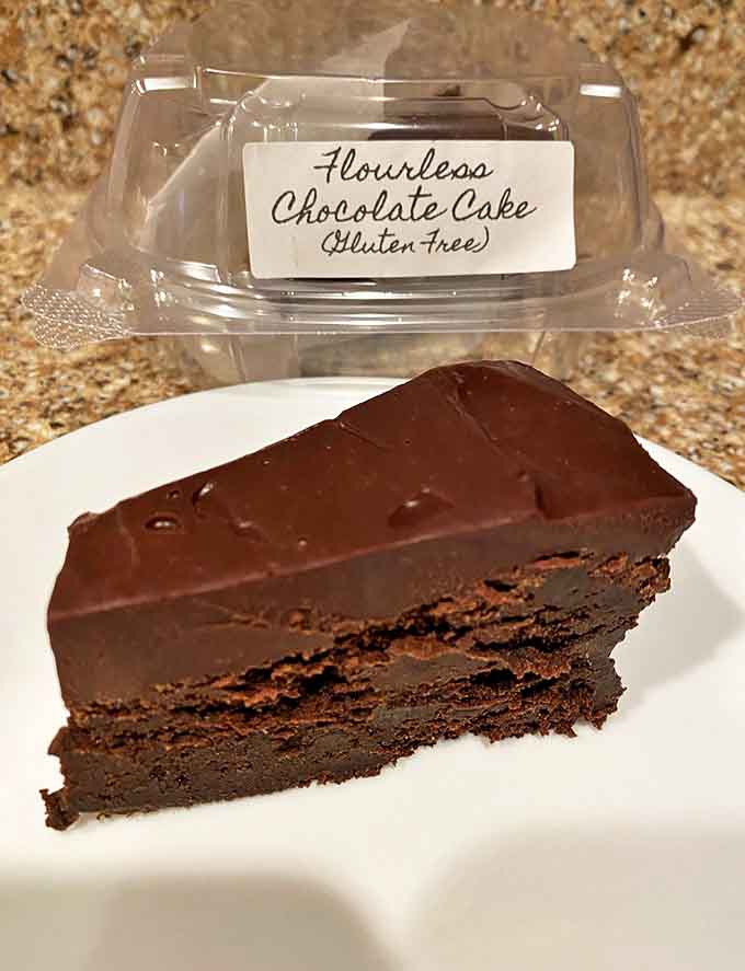 The flourless chocolate cake sits with quiet confidence, knowing it doesn't need fancy decoration to impress &ndash; one bite and conversation stops mid-sentence.