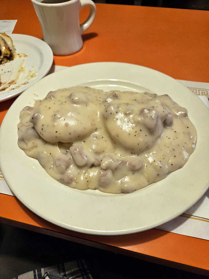 Biscuits and gravy at Fred's – where two fluffy islands float in a sea of peppery white gravy rich enough to require its own financial advisor.