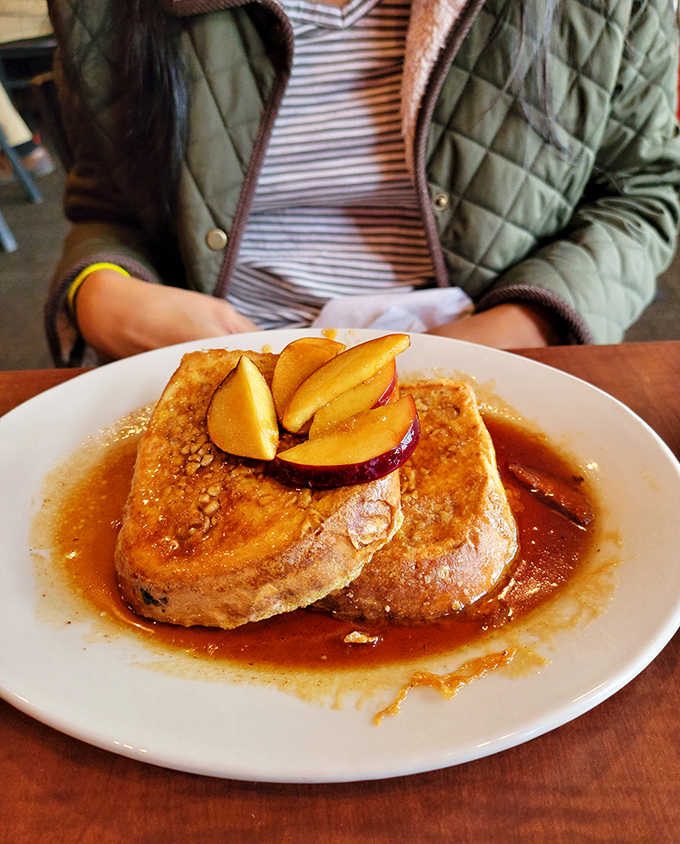 Cinnamon Apple French Toast that would make your grandmother jealous, topped with fresh fruit and swimming in sweet maple goodness.