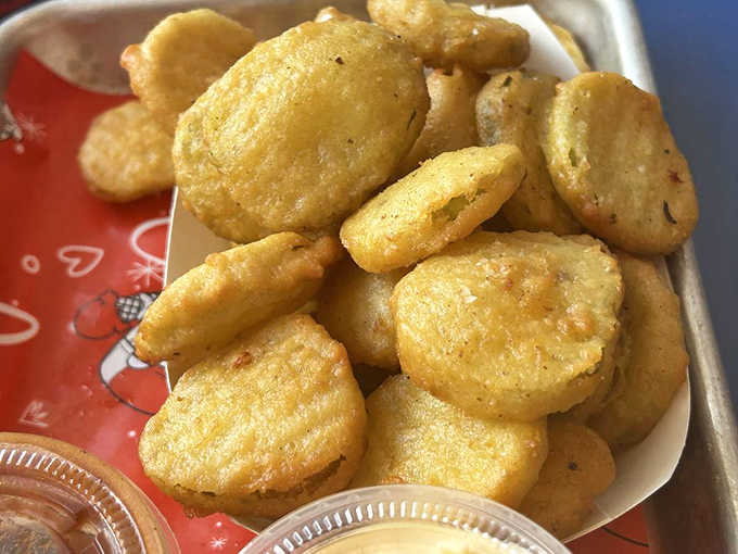 These aren't just fried pickles &ndash; they're tangy little flavor bombs wrapped in a crispy jacket, ready to cut through richness with their briny charm.