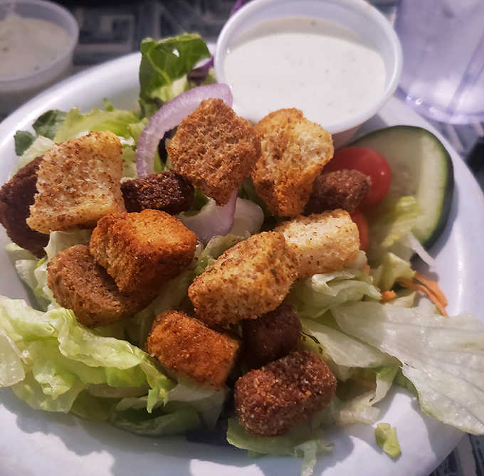 Fresh salad topped with crispy fried chicken proves that you can have your greens and your comfort food too, all on one plate.