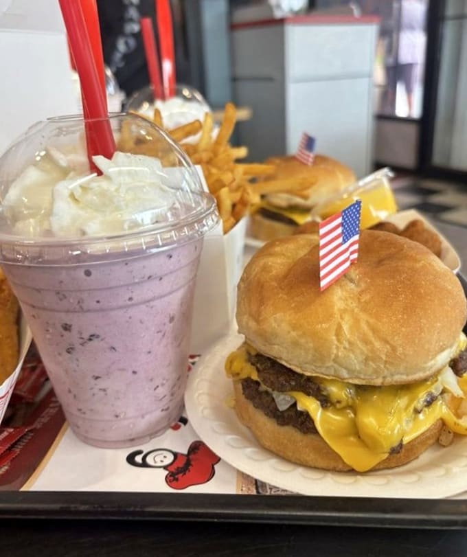 That blackberry shake looks like a purple dream, thick enough to require serious straw commitment and pure determination.