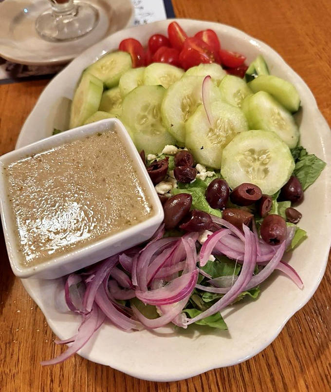A Greek salad that balances freshness with tradition &ndash; crisp vegetables, briny olives, and tangy dressing creating a symphony of flavors.