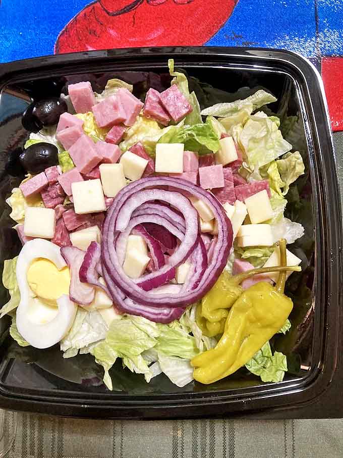 The antipasto salad offers a fresh counterpoint to pizza indulgence &ndash; a colorful arrangement of Italian classics with that signature tang.