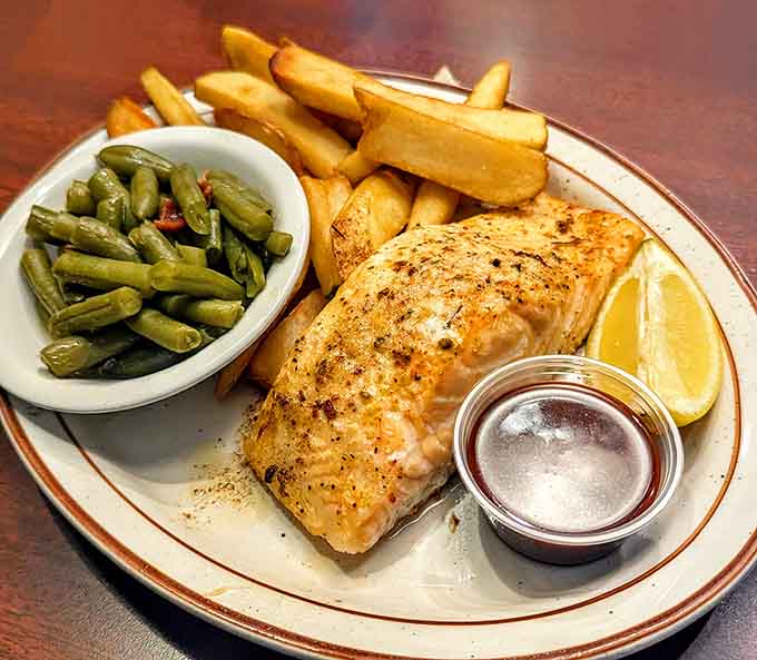 Grilled salmon with green beans and fries, showing this kitchen can handle anything you throw at it.