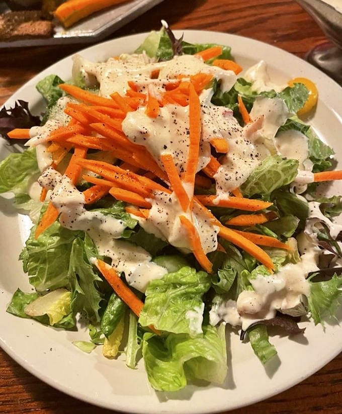 A garden-fresh salad that doesn't feel like punishment, with crisp greens and vibrant carrots under a dressing that makes vegetables feel indulgent.