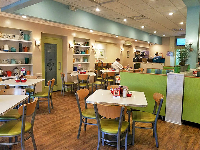 Soft teal walls and thoughtful décor create an atmosphere that says "stay awhile" – breakfast as an experience, not just a meal.