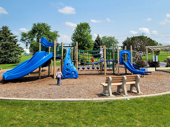 Kiwanis East Park offers modern playground equipment where kids can burn energy while parents secretly wish adult-sized versions existed for them too.