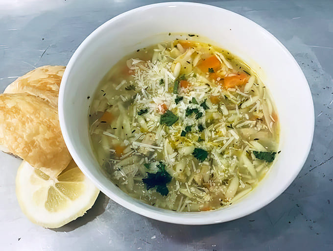 This lemon chicken orzo soup with a golden croissant on the side is comfort food that'll warm you from the inside out, perfect for Michigan's unpredictable weather.
