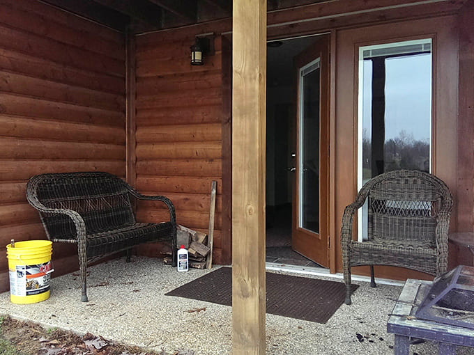 The covered porch becomes an extension of the living space, offering front-row seats to nature's ever-changing show.