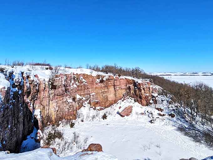 Winter transforms Blue Mounds into a snow-dusted wonderland, where the pink cliffs wear white caps like geological fashion statements.