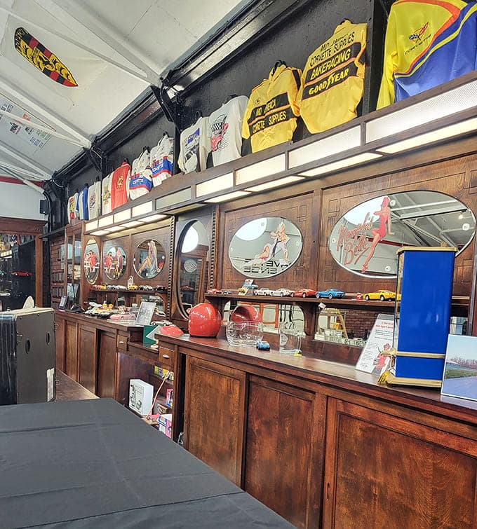 Racing suits, helmets, and championship memories line the walls like trophies in a hall of fame dedicated to speed and glory.