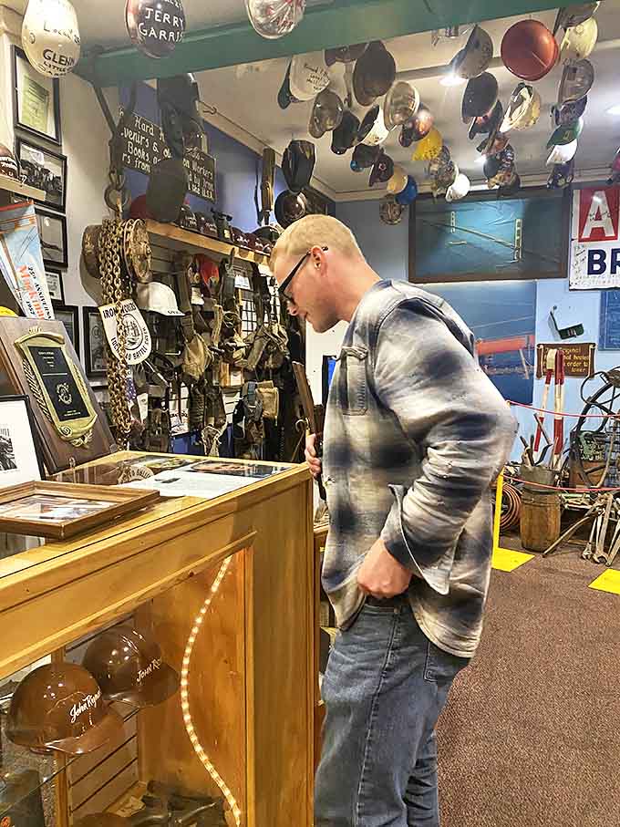 A visitor examines the fascinating collection of bridge memorabilia, each artifact connecting present-day pizza enthusiasts to Michigan's engineering past.