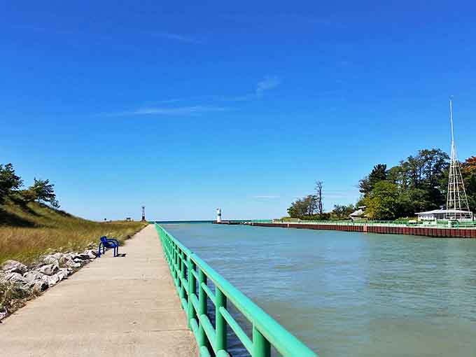Mears State Park's pier invites wanderers to venture into Lake Michigan, its green railings guiding visitors toward endless blue horizons.