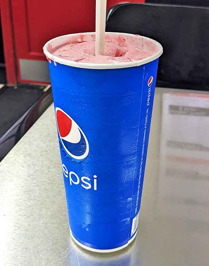 A strawberry shake so thick the straw stands at attention, with real fruit pieces suspended in creamy pink perfection.