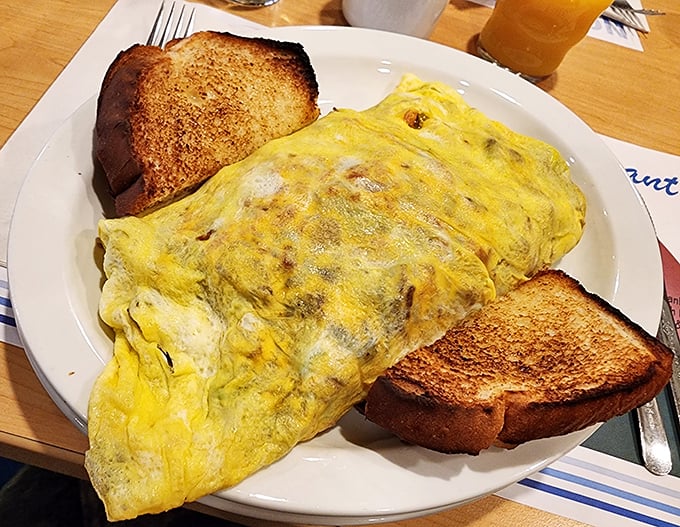 The classic American breakfast in its final form &ndash; a fluffy omelet that's seen things, flanked by toast soldiers ready for the syrup battlefield. 