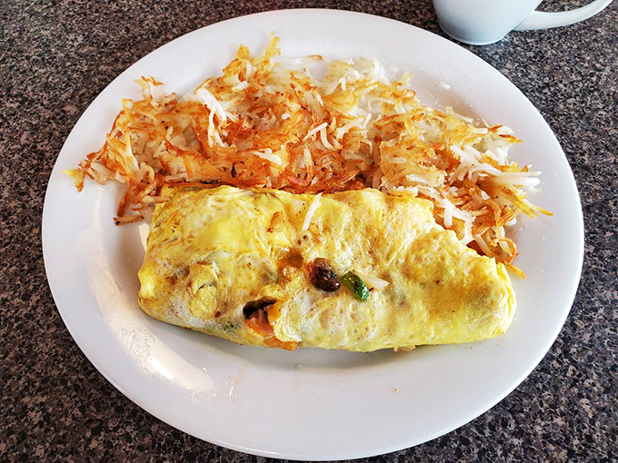 This fluffy omelet alongside crispy-edged hash browns creates the breakfast duet you didn't know you needed until that first heavenly bite.