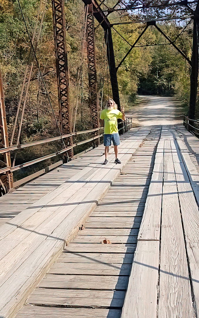 A visitor pauses mid-span, perhaps feeling that peculiar sensation locals describe as "being watched" from the surrounding woods.