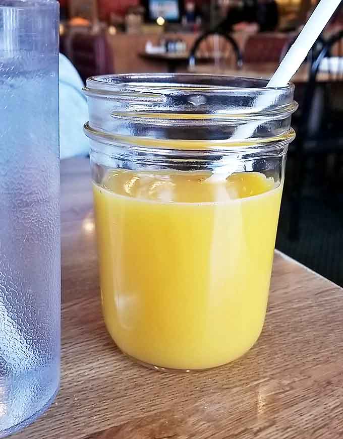 Orange juice served in a mason jar &ndash; because vitamin C tastes better when it comes with a side of rustic charm.
