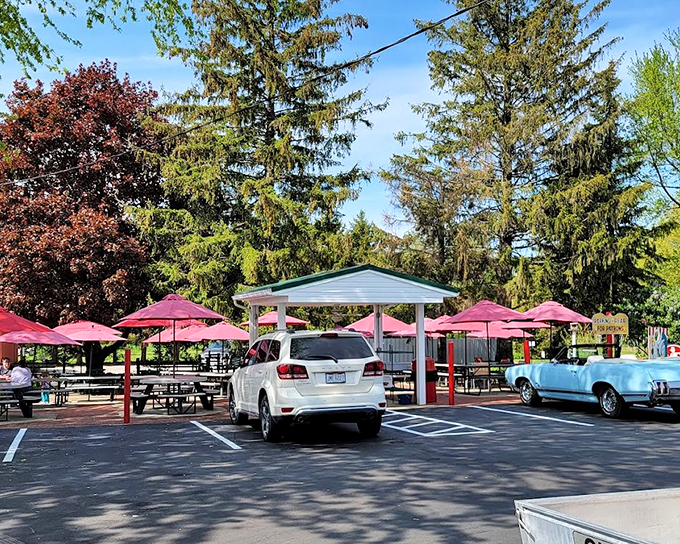 Outdoor seating under red umbrellas creates the perfect setting for making memories over America's favorite roadside treats.