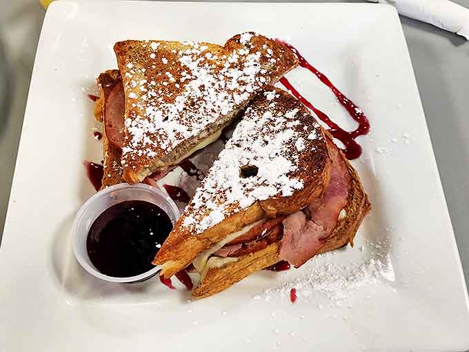 French toast that looks like it just walked off a magazine cover! Dusted with powdered sugar and ready for its close-up. Berry compote adds that perfect sweet tang.