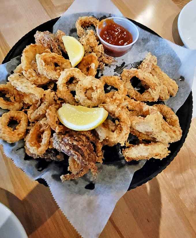 Calamari so perfectly crisp you'll forget you're eating something that once swam rather than flew, served with lemon wedges for that perfect zing.