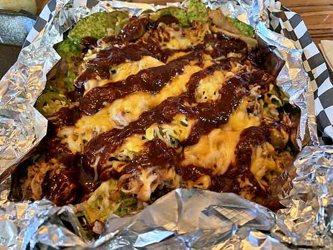 Pulled pork nachos that redefine indulgence &ndash; a mountain of chips, cheese, and smoky meat that's worth every delicious calorie.