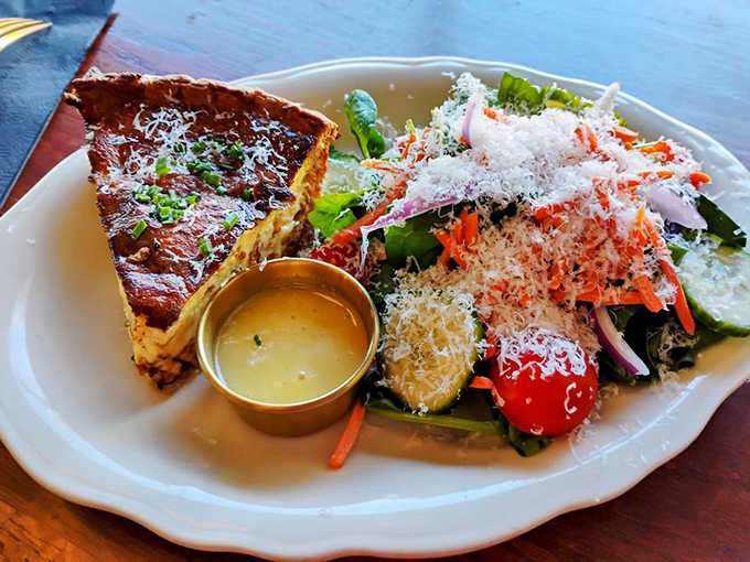 Quiche Lorraine with a side salad, because nothing says "I'm being responsible" like eating vegetables alongside your butter-laden egg pie.