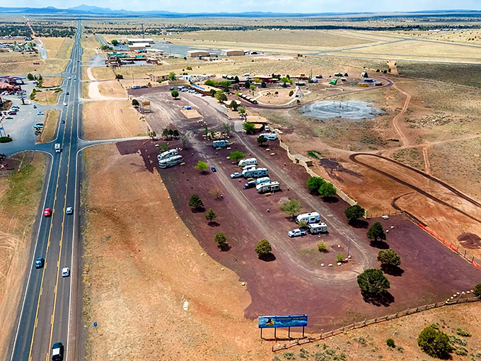 The Flintstones Campground welcomes modern nomads with its colorful prehistoric-themed entrance and promise of "Buffalo Lodge" comforts.