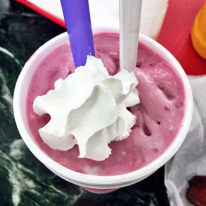 A raspberry shake topped with whipped cream &ndash; thick enough to hold your straw upright and pink enough to match the building.