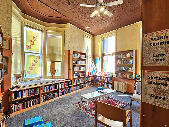The reading area beneath ornate ceiling tiles invites visitors to sample first chapters, like a literary tasting room for the bibliophile's soul.
