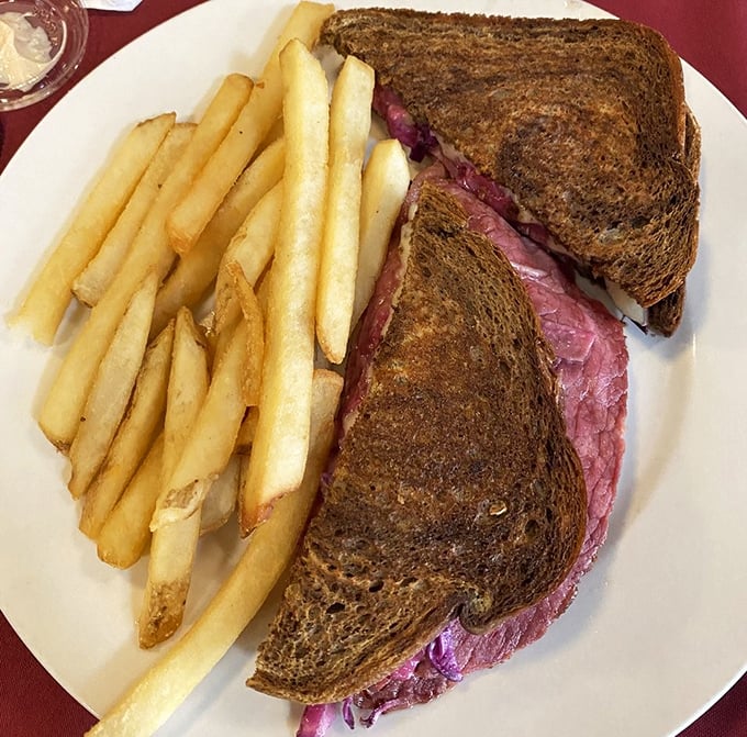 Corned beef skyscrapers on rye foundations with sauerkraut clouds and Swiss cheese sunshine &ndash; comfort food architecture at its finest.