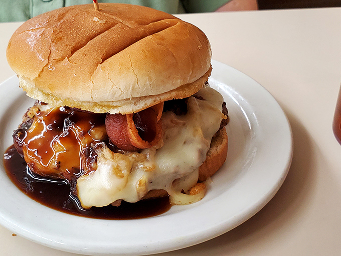 The Rodeo cheeseburger arrives like a beautiful mess &ndash; melted cheese cascading over the patty, bacon peeking out, sauce pooling invitingly on the plate.