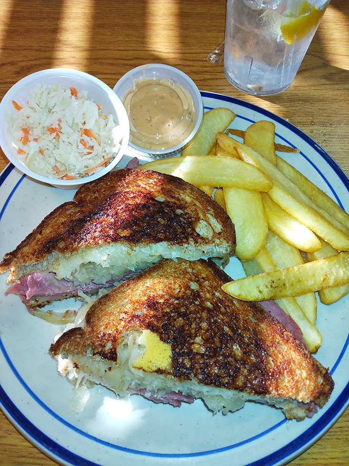 The ultimate sandwich balancing act &ndash; tangy sauerkraut, rich corned beef, and melty Swiss cheese creating harmony between two perfectly grilled rye slices.