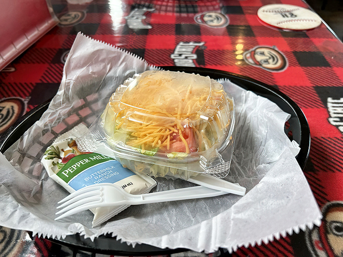 A fresh side salad offers a crisp counterpoint to the heartier fare – even vegetables dress in team colors here.