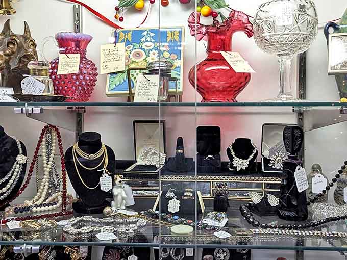 Vintage jewelry waits patiently under glass – pearls that adorned grandmothers, rhinestones that sparkled at sock hops, each piece with a story untold.