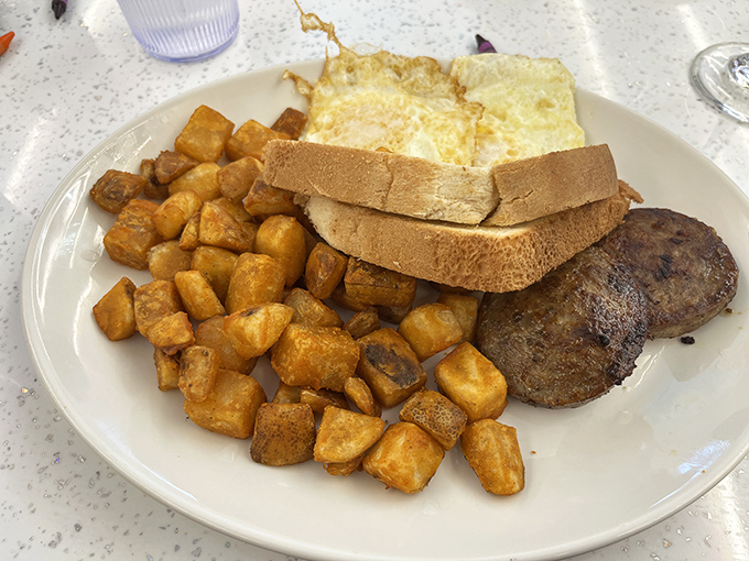 Sausage Platter: The breakfast trinity &ndash; golden home fries, perfectly cooked eggs, and savory sausage patties &ndash; a holy alliance of morning satisfaction.